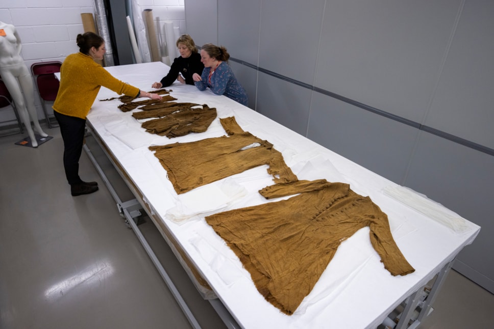 Curators examine clothing discovered on Kinloch Moor, 18th century ...