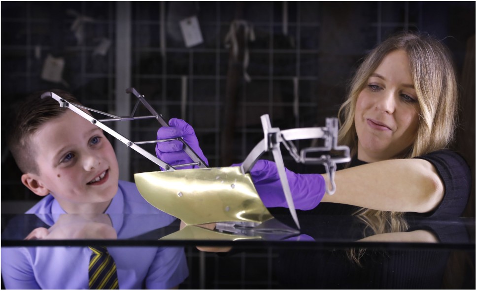 Harris Craig (9) watches curator Ailsa Hutton prepare a model at the ...