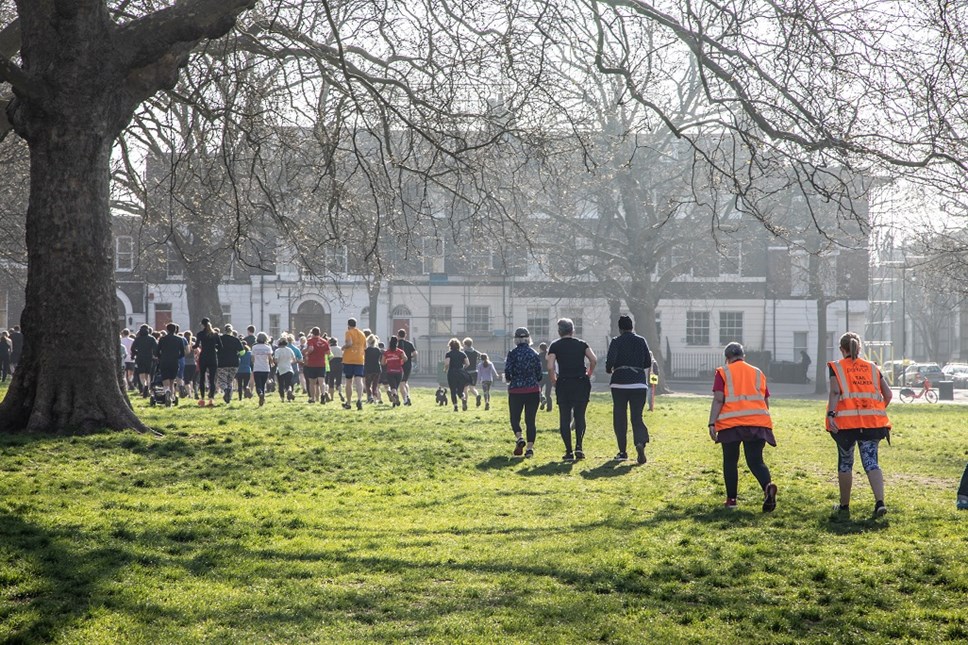 Runners take part in the weekly Highbury Fields parkrun on a sunny day ...