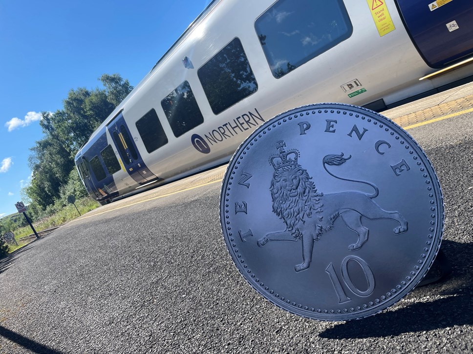 Image shows 10p promo coin at Windermere station | Northern News