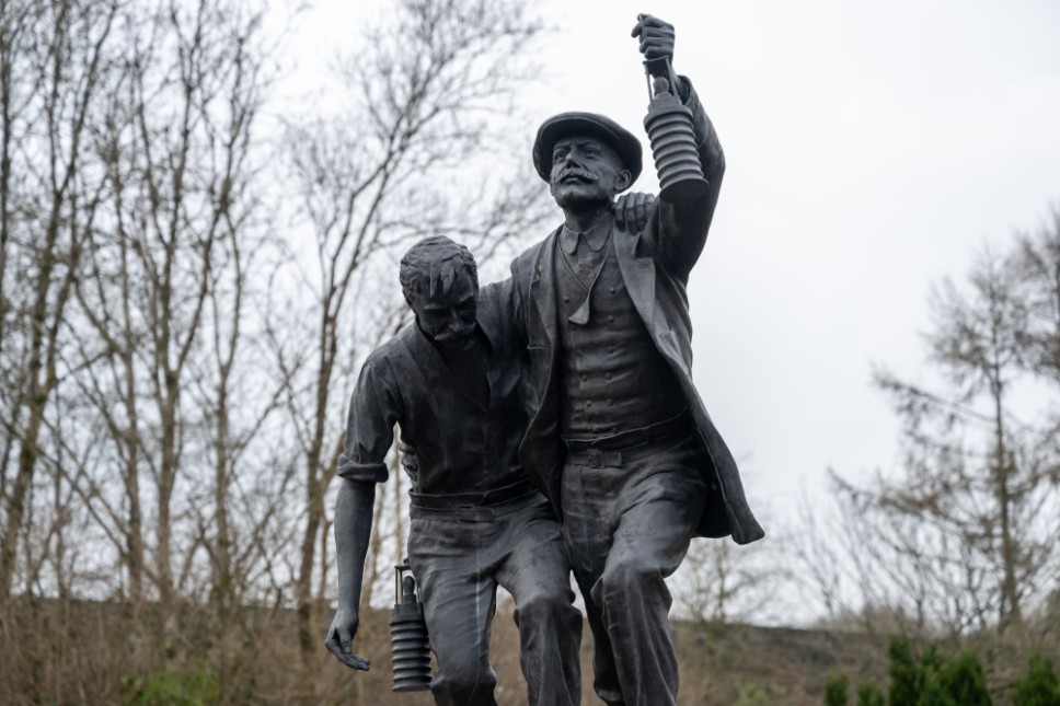 Bronze statue which depicts a rescue worker coming to the aid of a ...