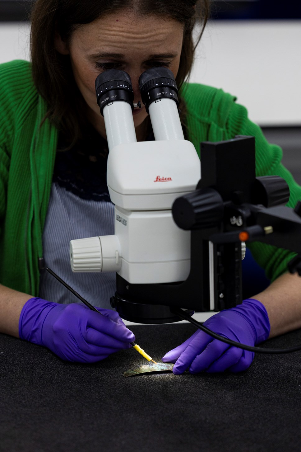 Conservator Bethan Bryan working on the Roman arm guard. Photo (c ...