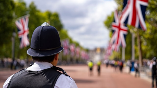 Officer pictured with union jack flags in background cropped