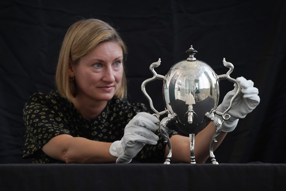 Curator Lyndsay McGill with an ovoid coffee pot, silver, by John Rollo ...