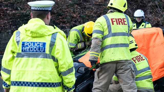 Officer with fire and rescue colleagues - Hero Image