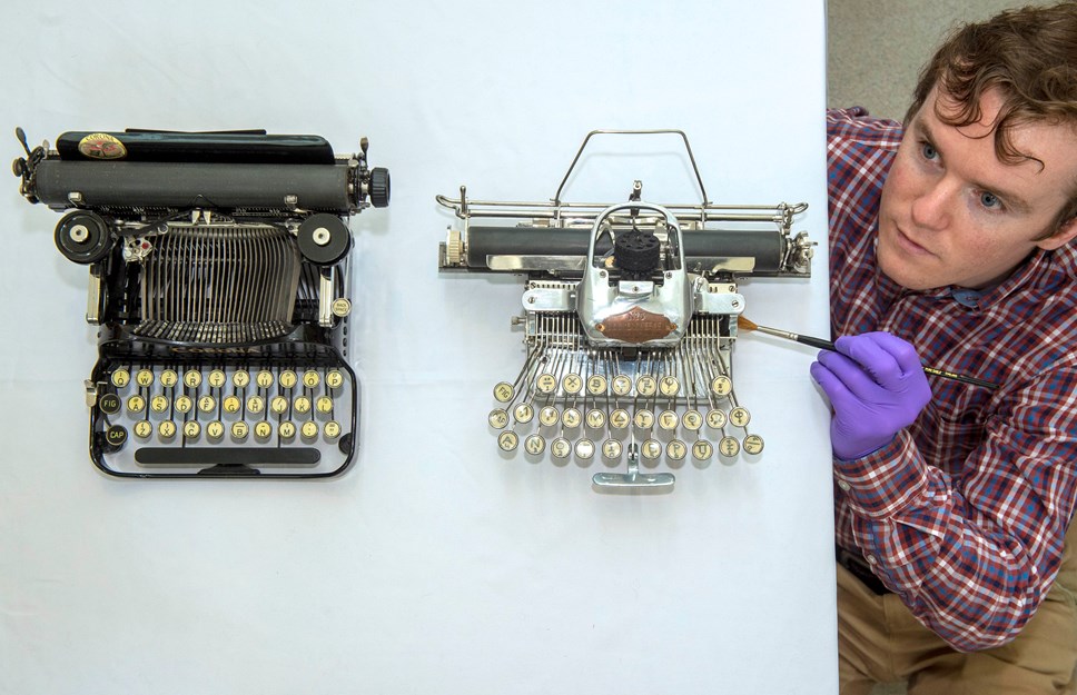 PhD student James Inglis with two of the typewriters featured in the ...