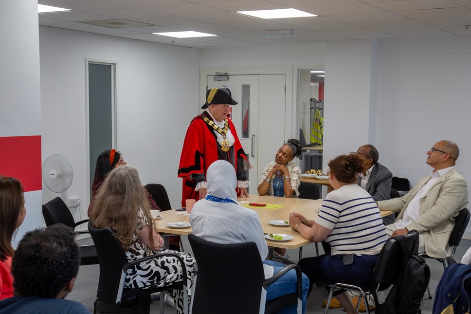 The Mayor of Islington standing at a volunteer fair near a table ...
