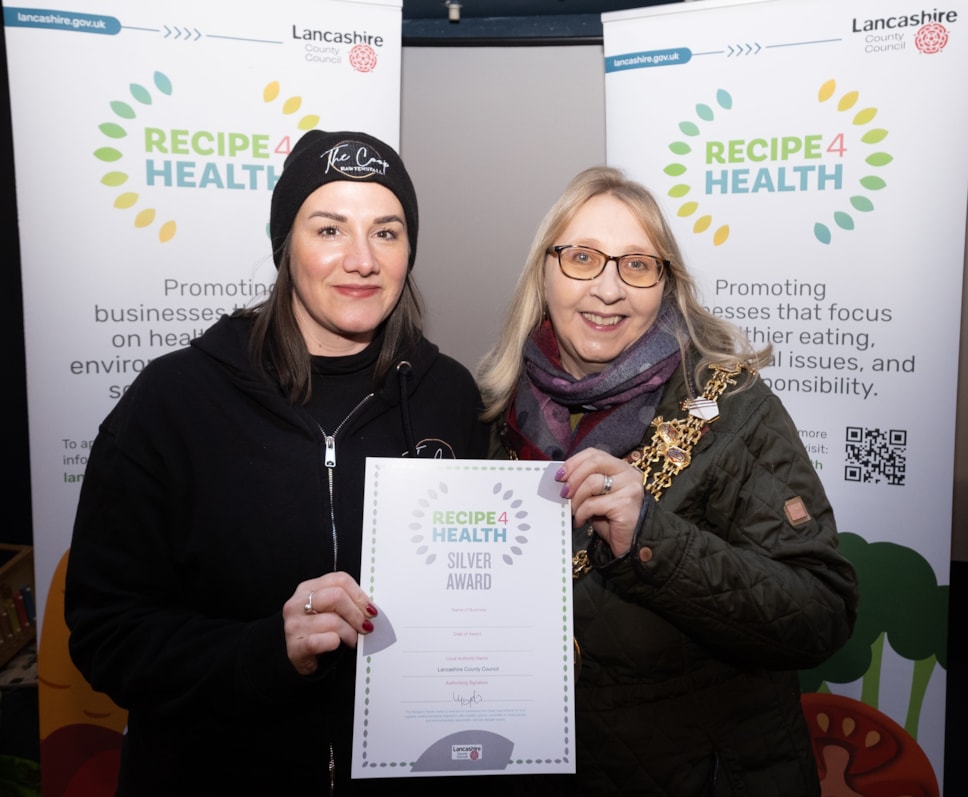 The Coop representative is presented witht the Silver Award by the ...