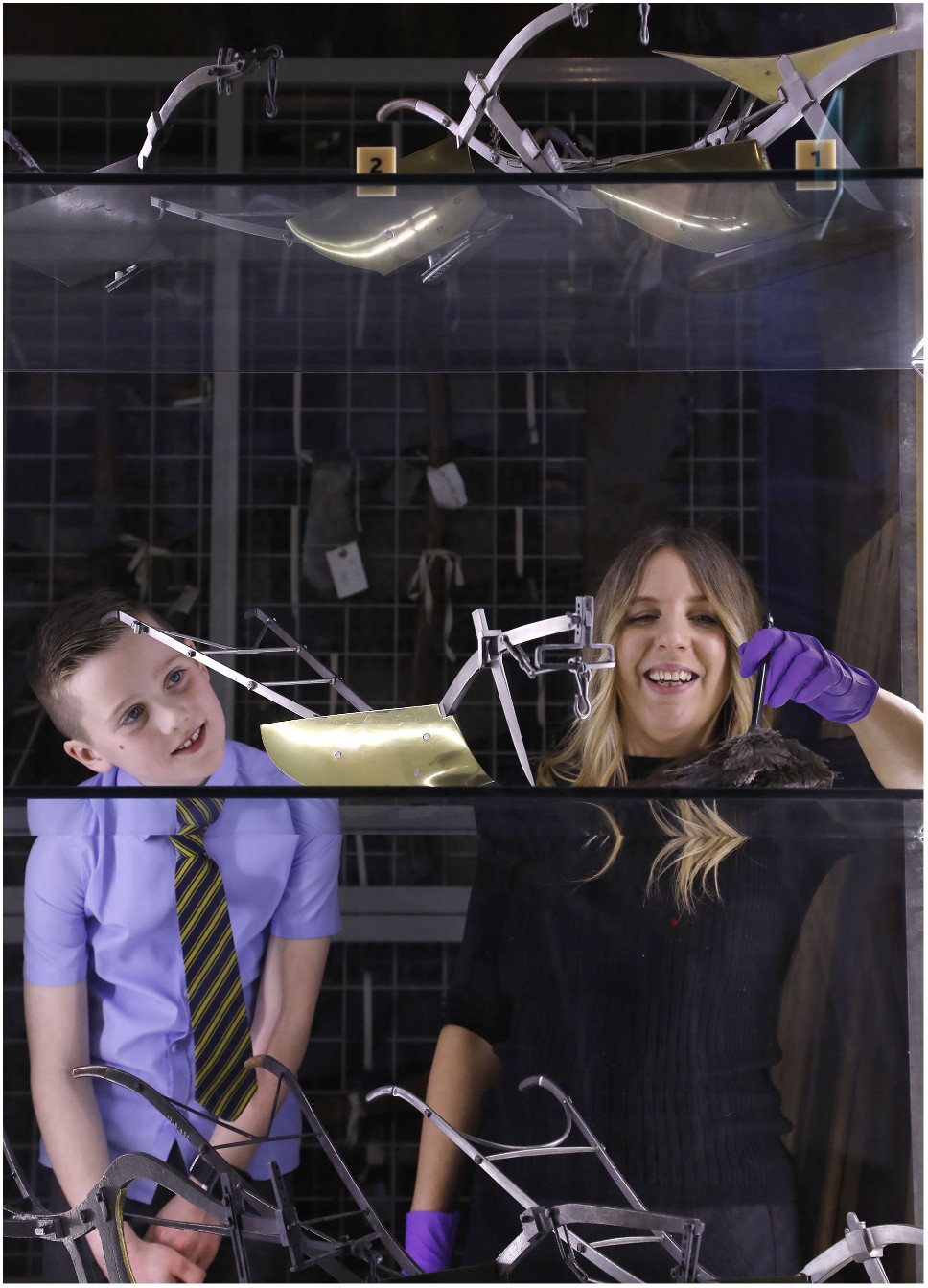 Harris Craig (10) watches curator Ailsa Hutton prepare a model at the ...