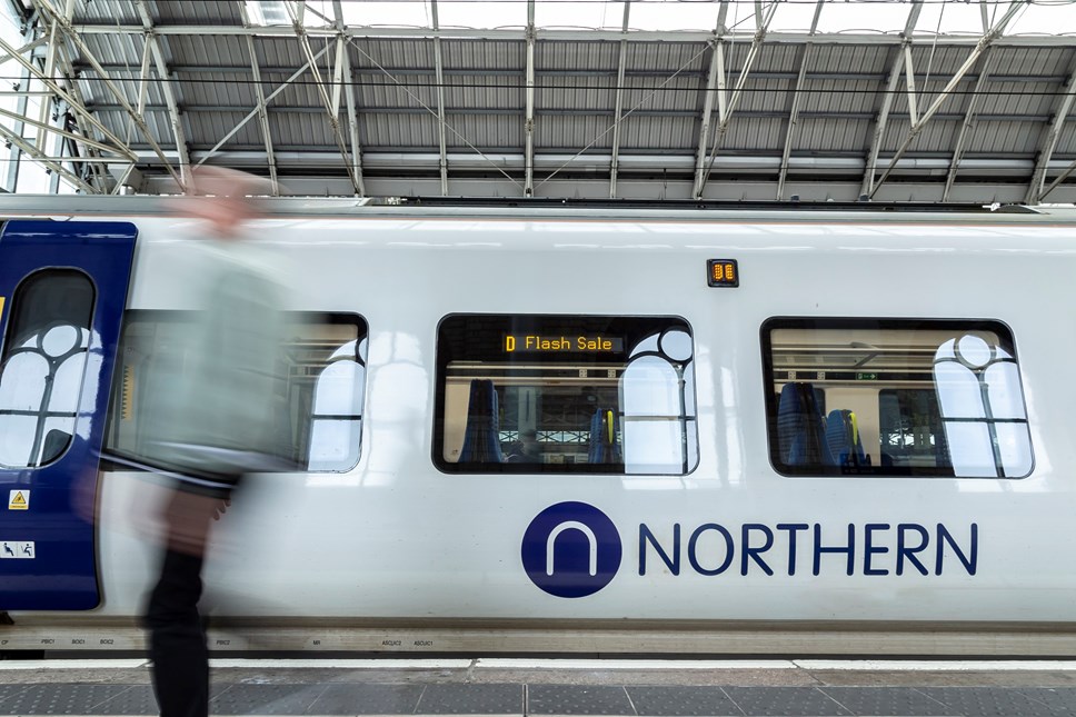 Image shows passenger alongside Flash Sale branded Northern train ...